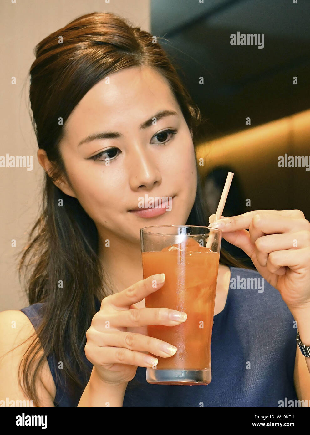 Japanese journalist Yuri Takeda holds an eco-friendly wooden straw in ...