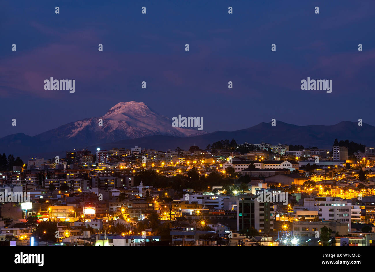 Cityscape of Quito at night with the impressive Cayambe volcano, Andes ...