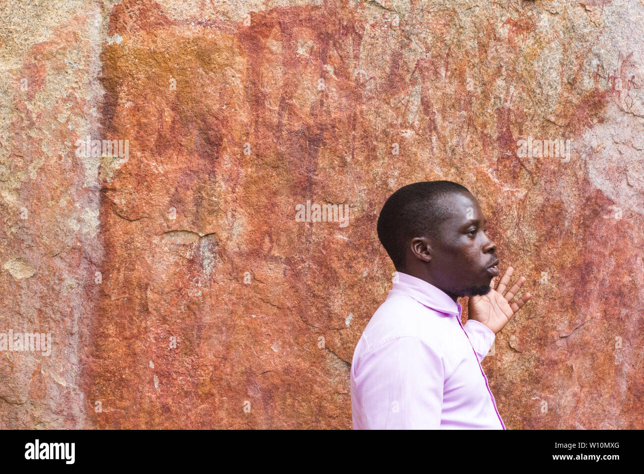 Local historian explaining some 8000 years old rock art paintings in ...