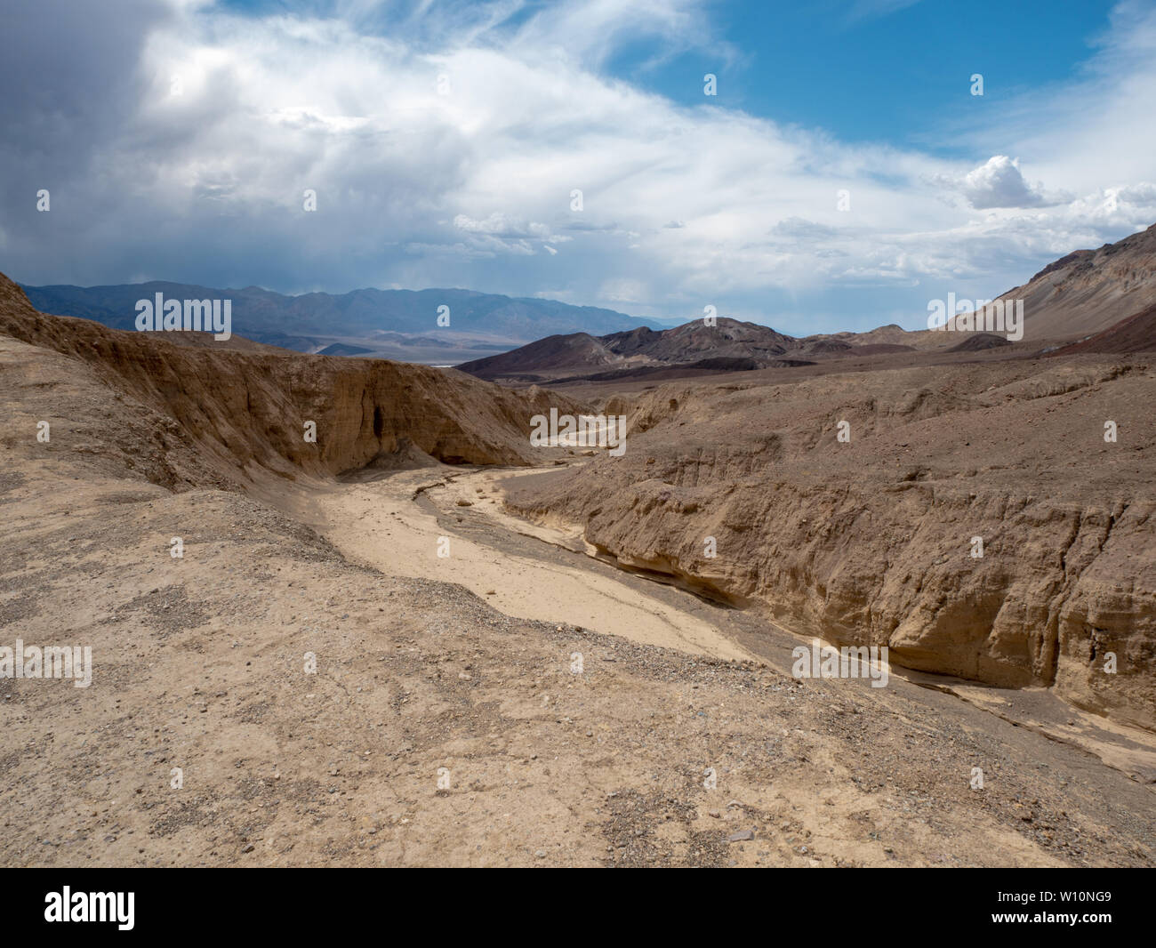 Water erosion formed wash (ravine) and approaching rain storm in Death ...