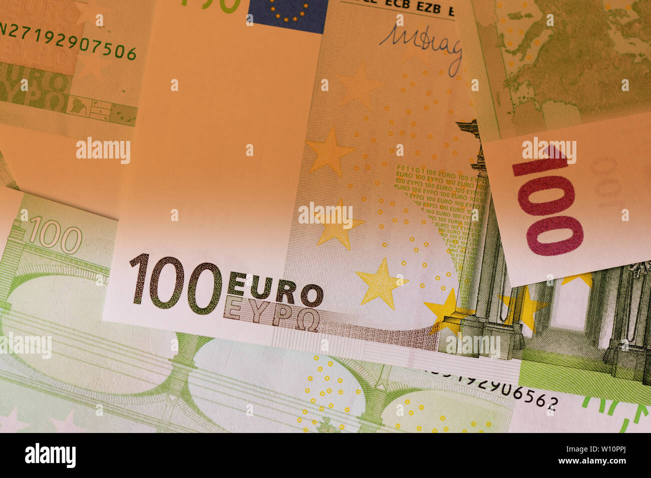 One hundred euro notes close up brown color toned Stock Photo - Alamy