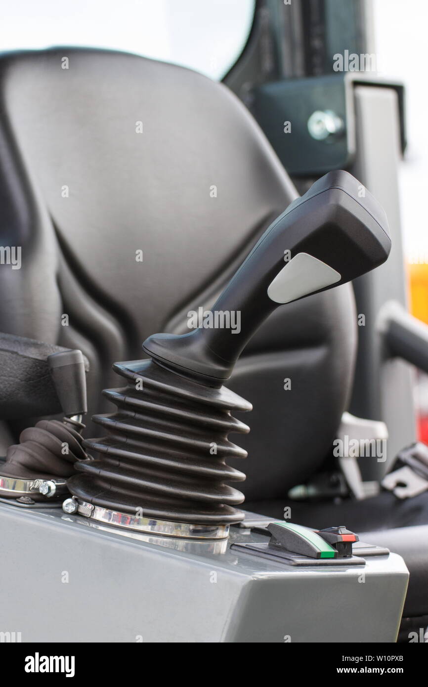 Operating control panel and black vehicle seat in background, detail ...