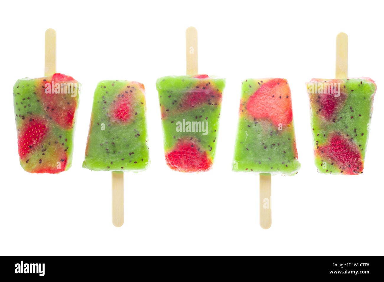 flat lay of handmade ice popsicles with kiwi and strawberry filling ...