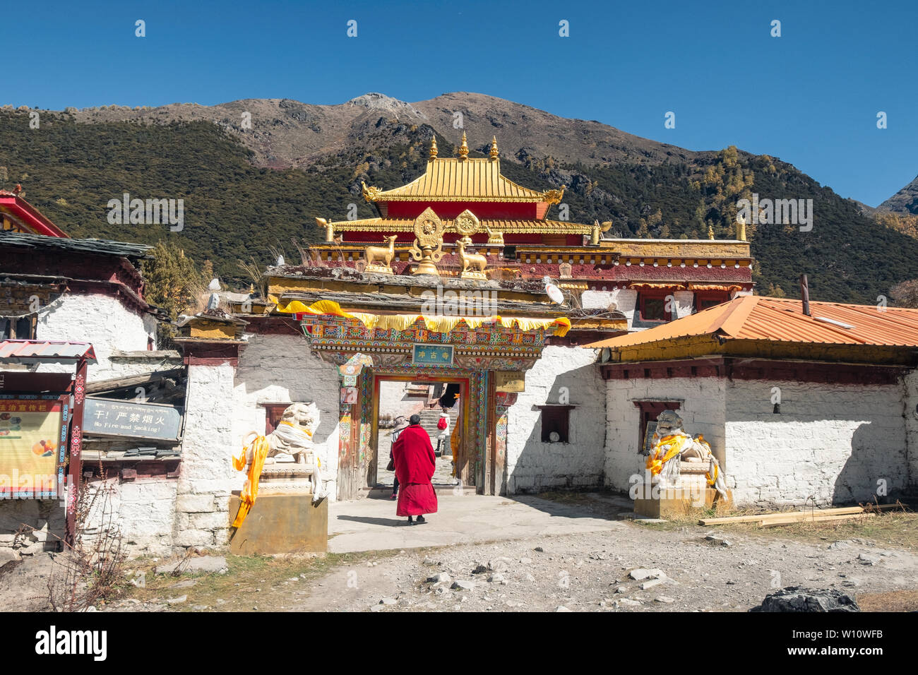 Sichuan, China - Oct 22 2018 : Monk Tibetan standing on gate at ancient ...