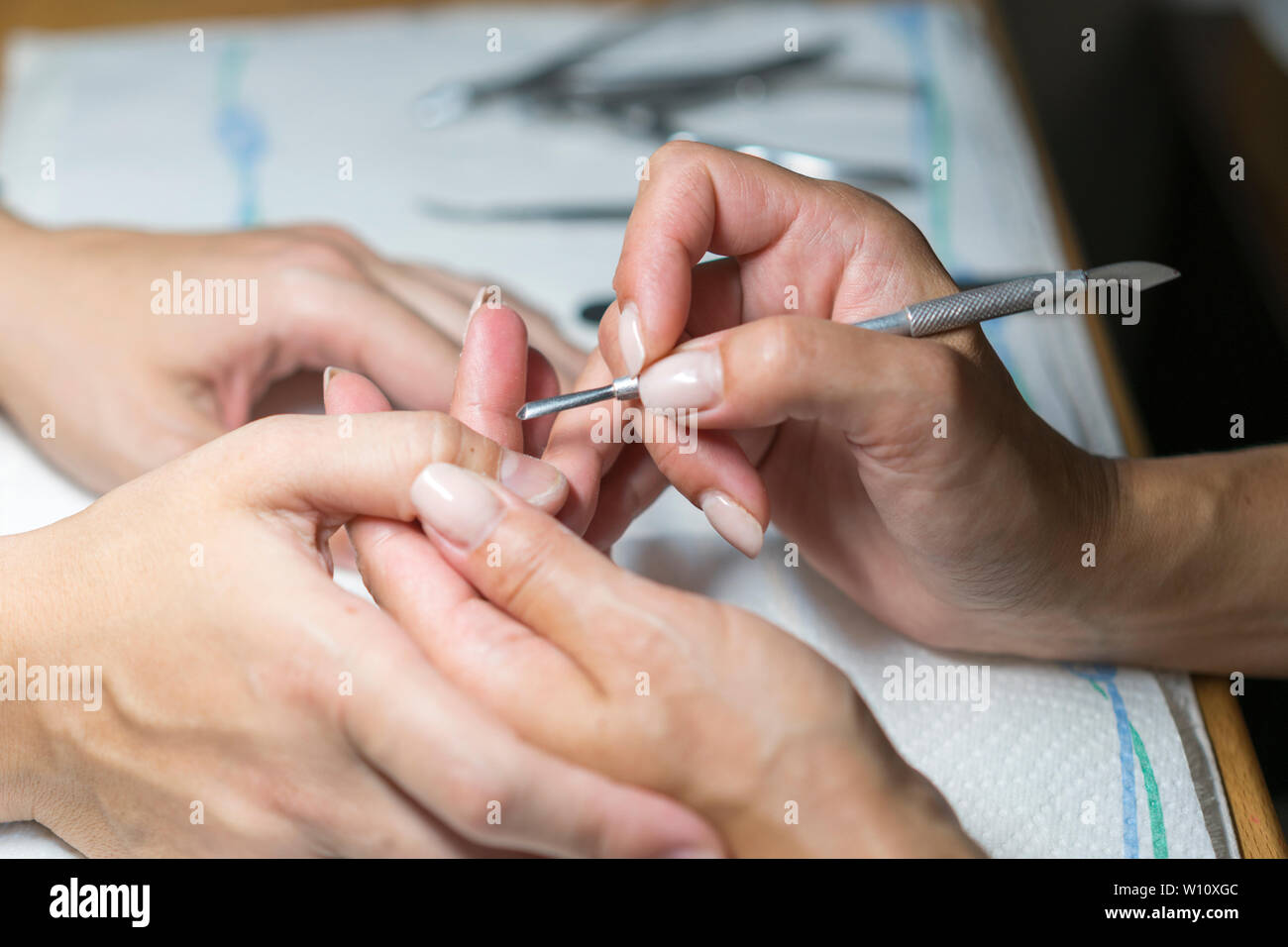 Close up woman hand while process of manicure in nail shop. Beautiful ...