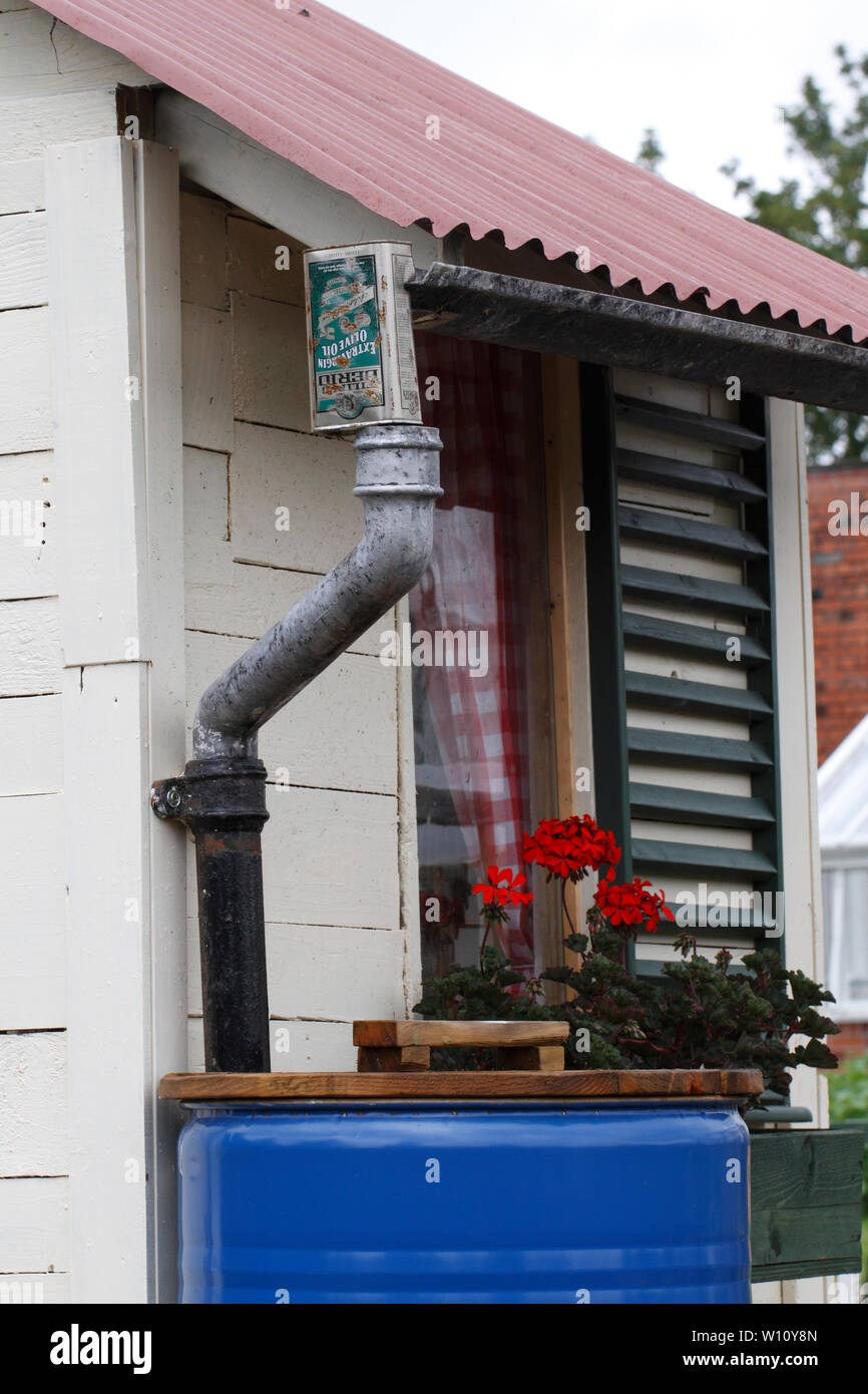 Cooking oil can being used as part of a Heath-Robinson guttering Stock ...