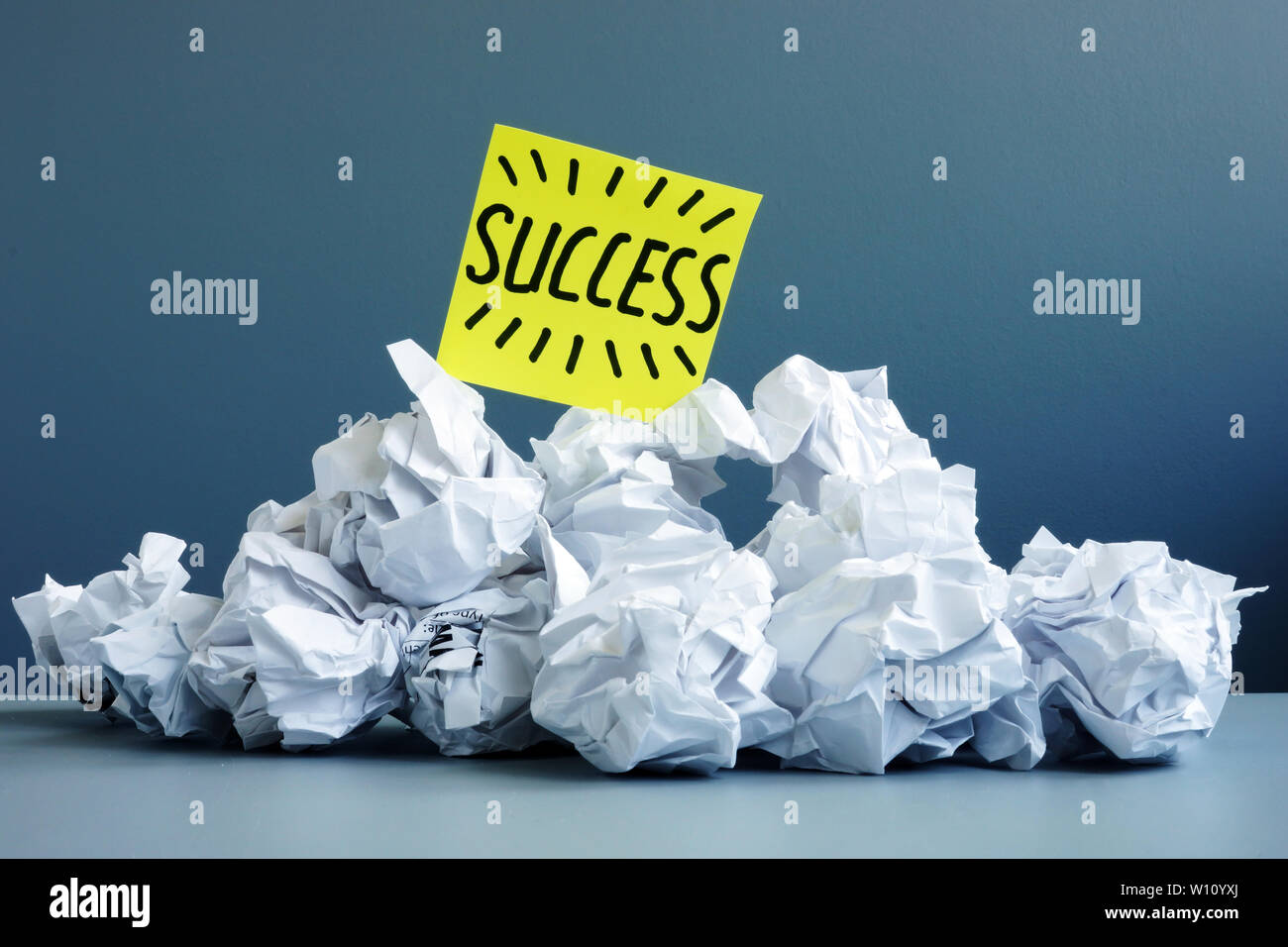 Stack of paper balls as symbol of failure and word success on top Stock ...