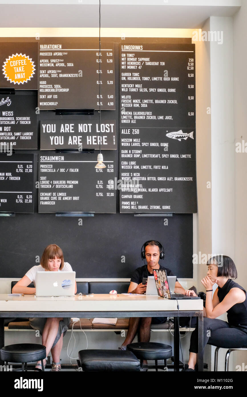 Trendy cafe with people working on laptops , Berlin Stock Photo - Alamy