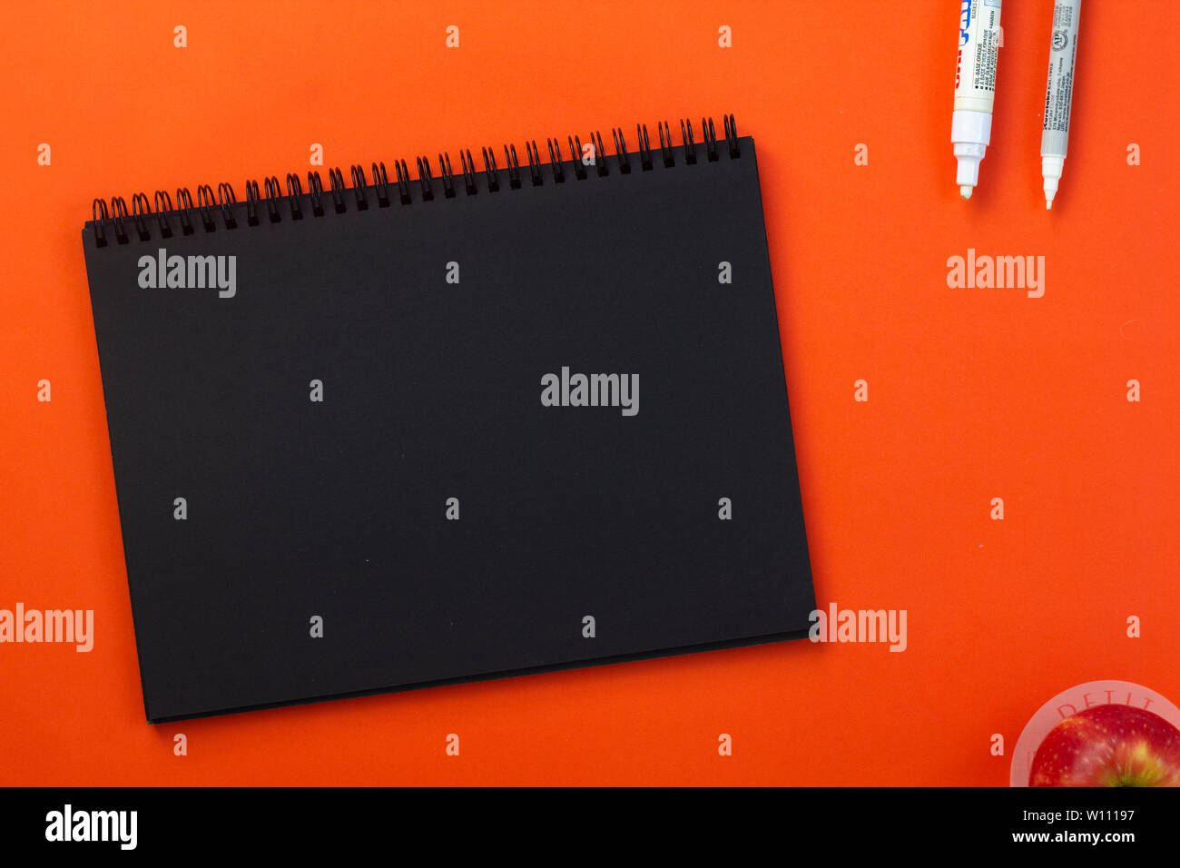 Blank black notepad on bright red background Stock Photo - Alamy