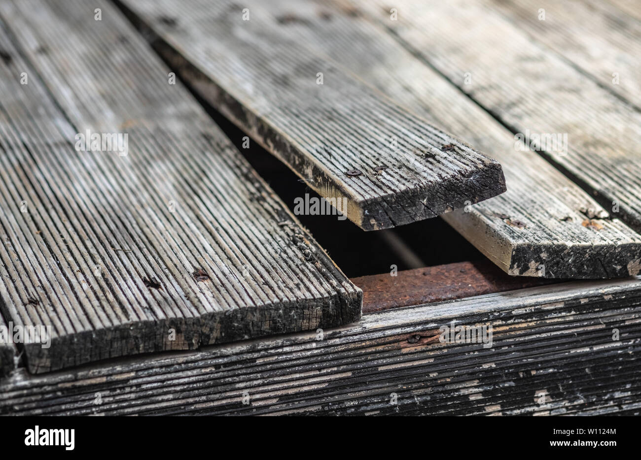 Exterior pine wooden floor bending due to Climate Change, front focus ...