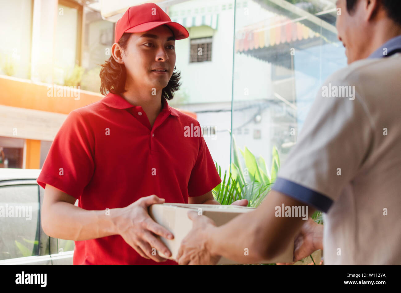 smart home delivery service man in red uniform smiling and handing ...