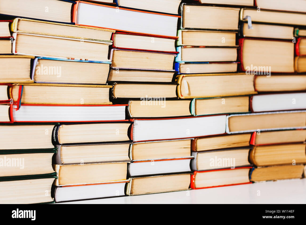 Stack of old book education concept background, many books piles with ...