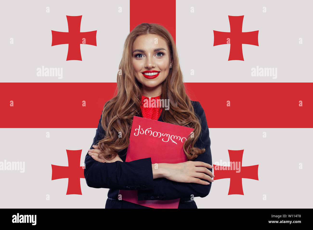 Happy girl student with red book against the Georgia flag background ...