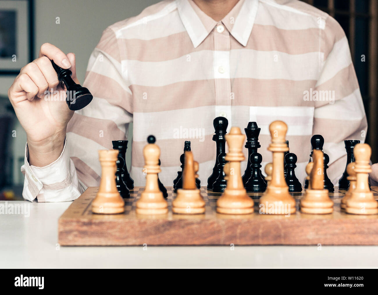 Wooden chess pieces on a chessboard, chess game woman player makes a ...