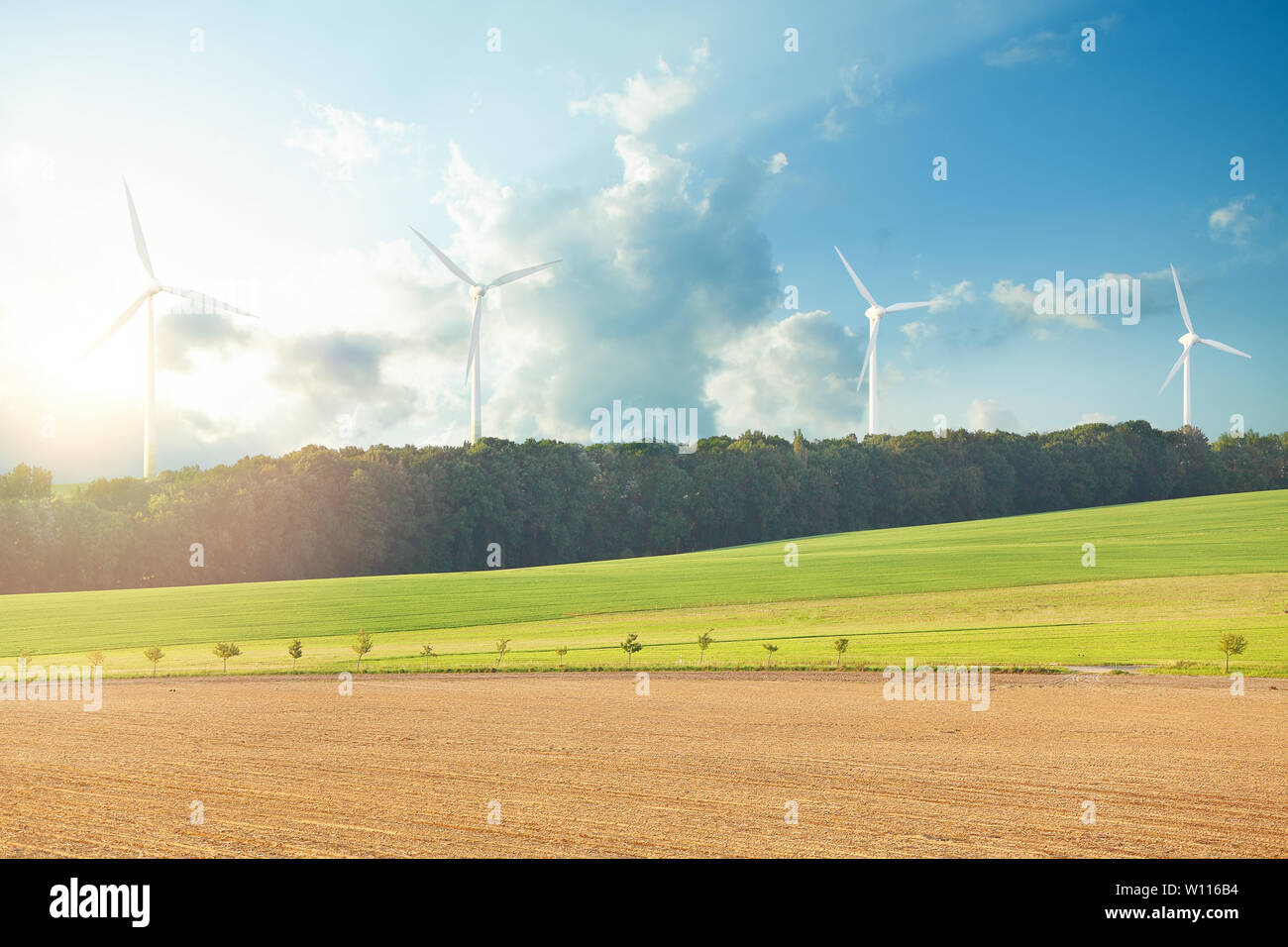 Wind turbine farm power generator in beautiful nature landscape for ...