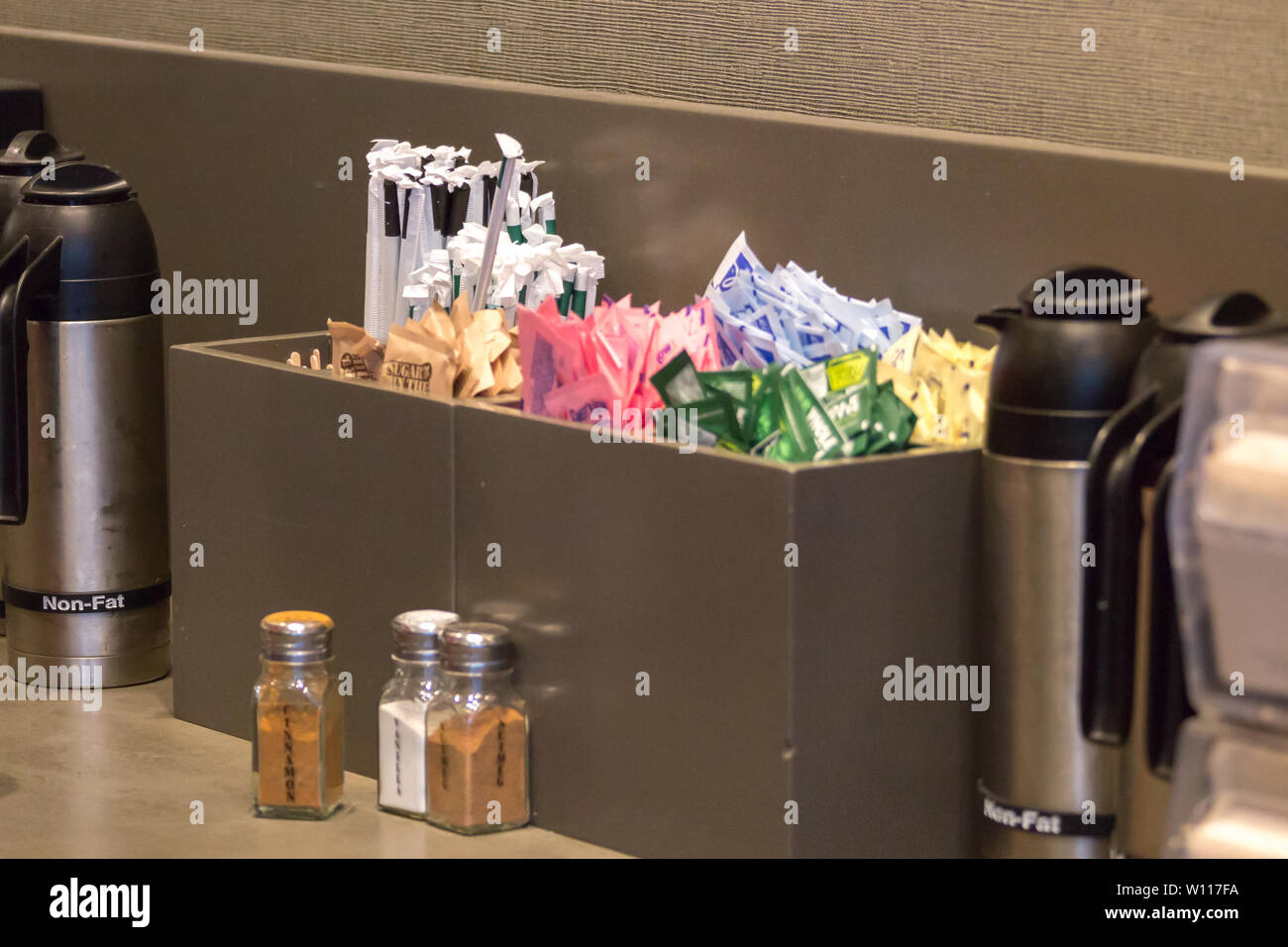 NEW YORK, USA - MAY 15, 2019: Counter in Starbucks cafe with Straws and ...