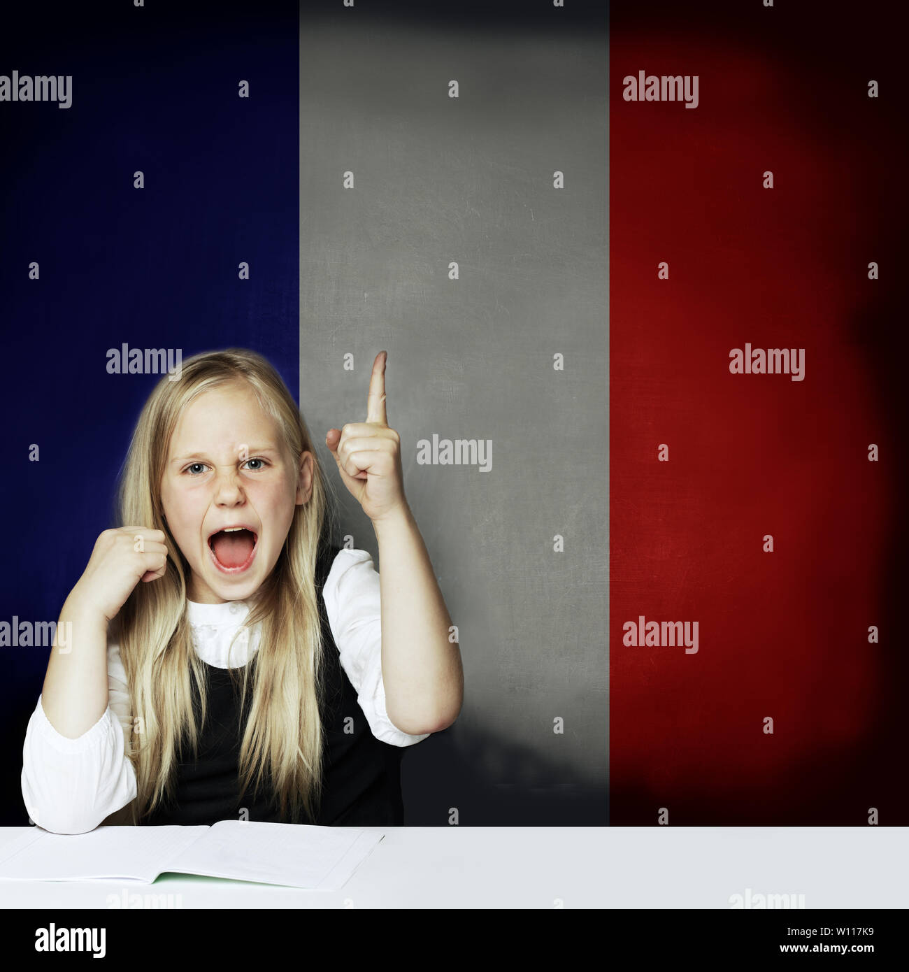 Learn french language concept. Happy child girl student pointing up and ...