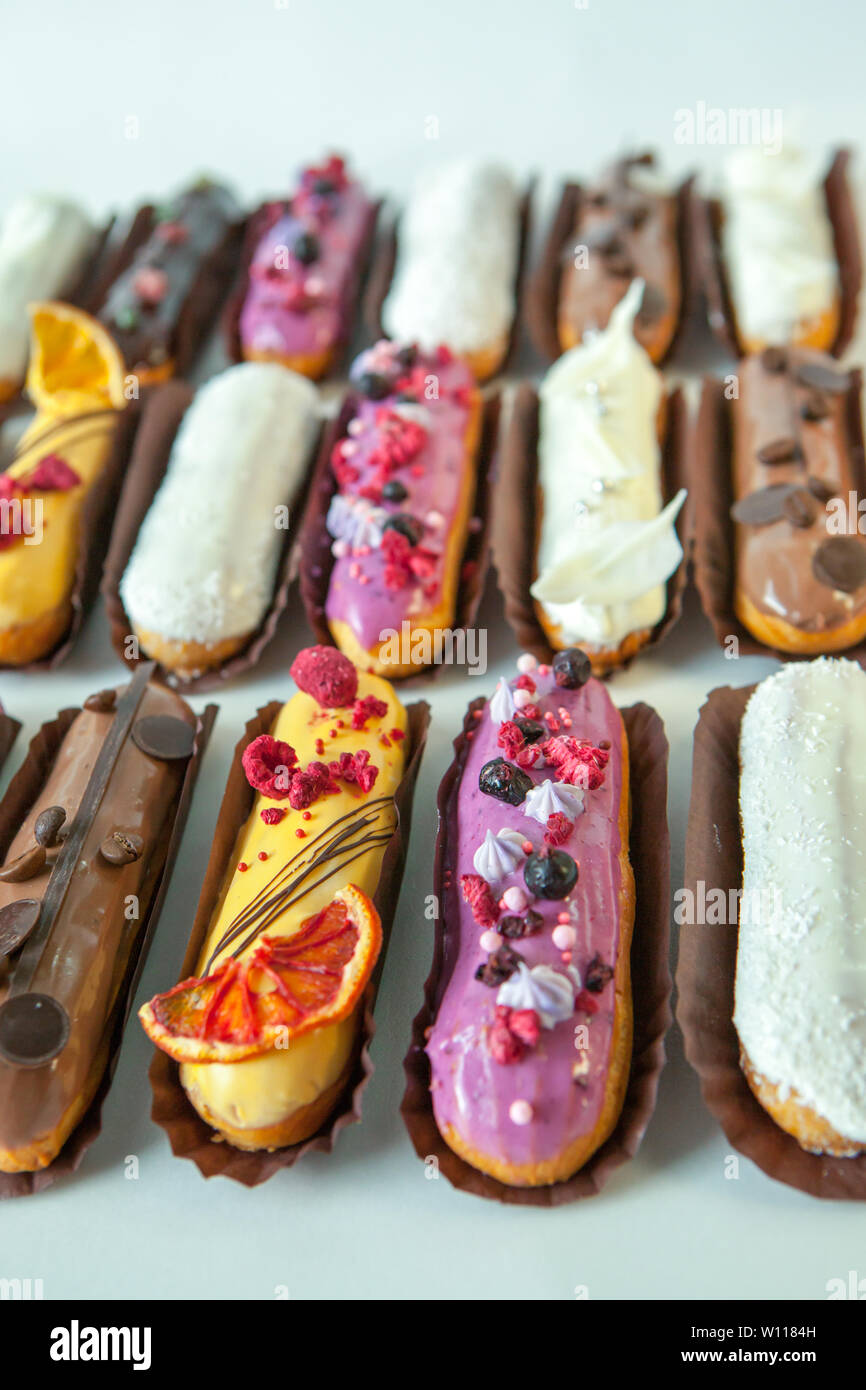 Set of several eclairs with various fillings and design isolate on a ...