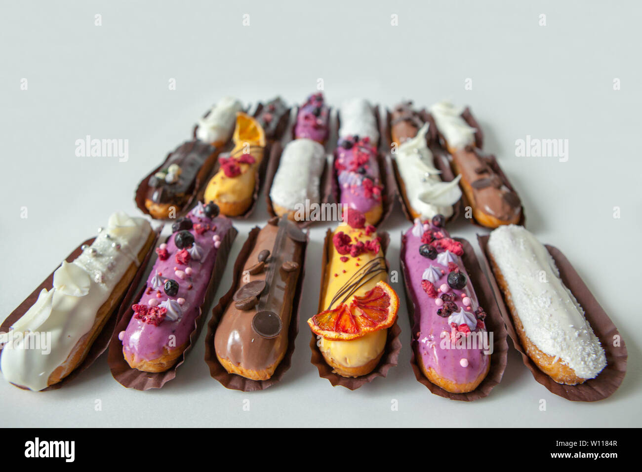 Set of several eclairs with various fillings and design isolate on a ...
