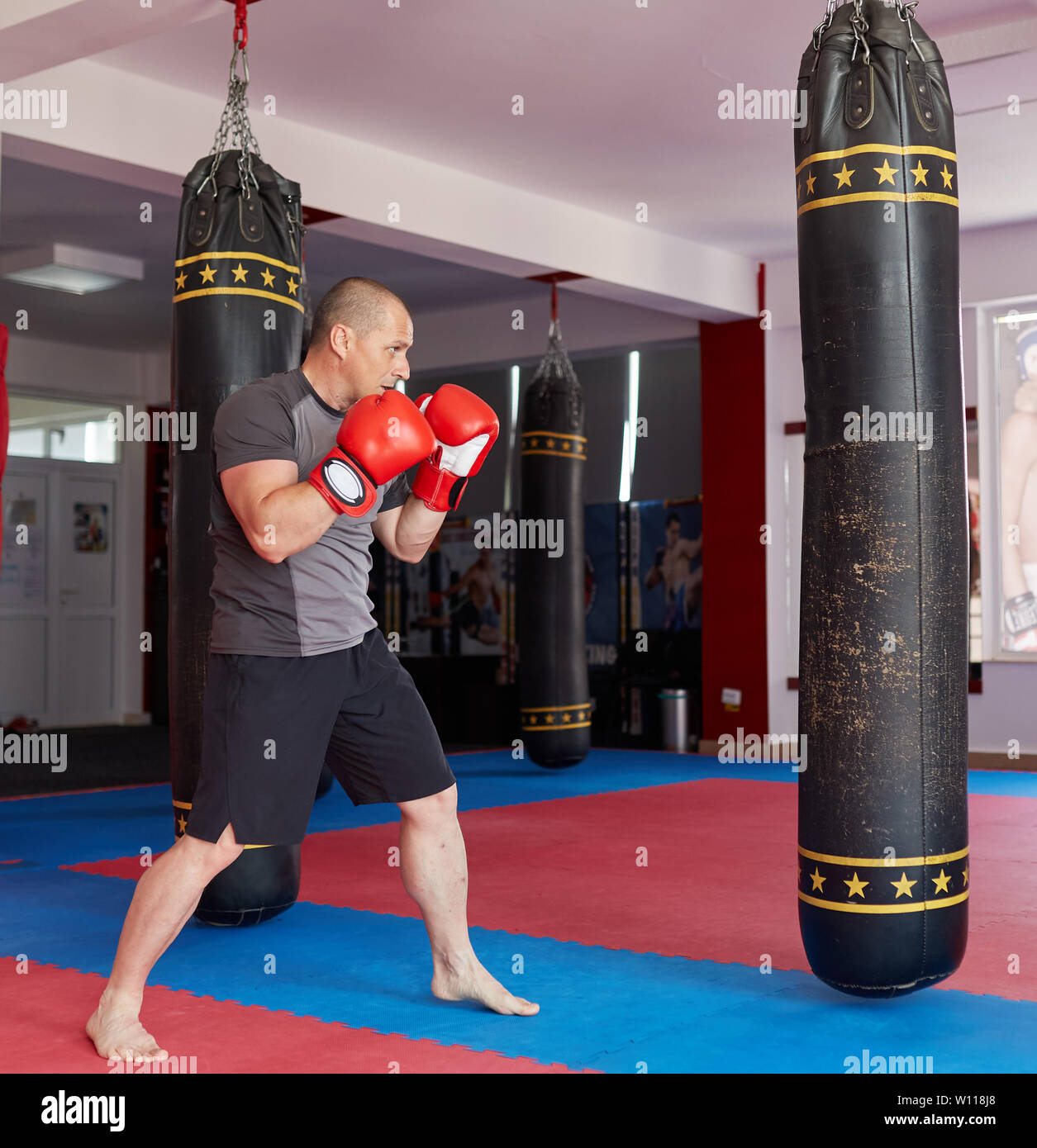Boxer working with the heavy bag Stock Photo - Alamy