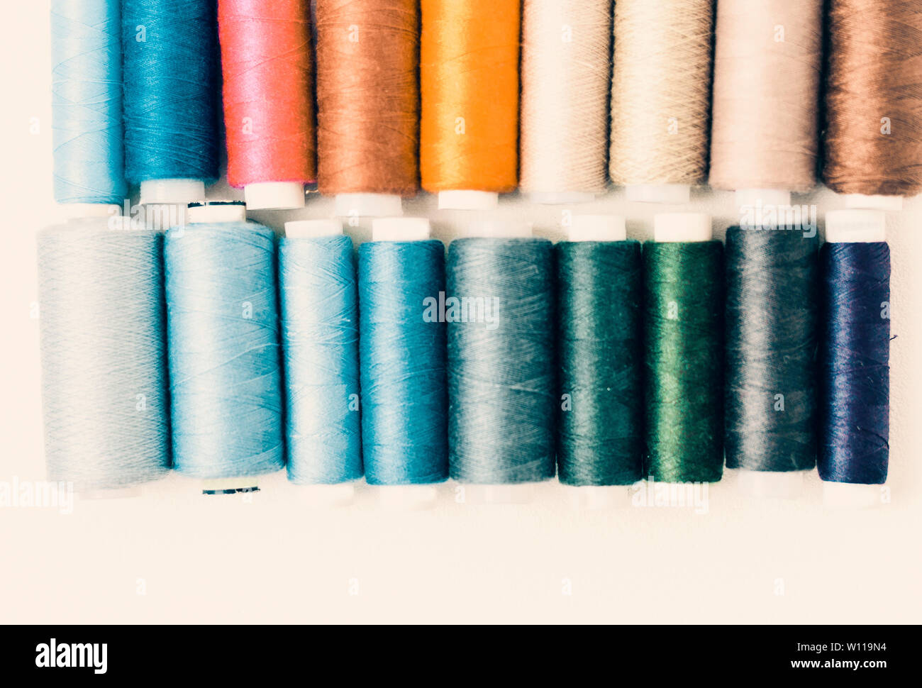 Colored sewing thread coils on white background with copy space for ...