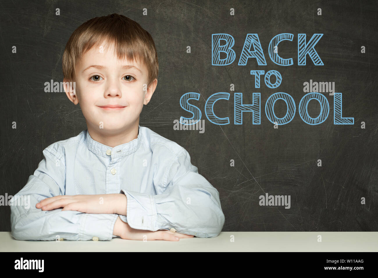 Back to school text and happy kid on chalkboard background Stock Photo ...