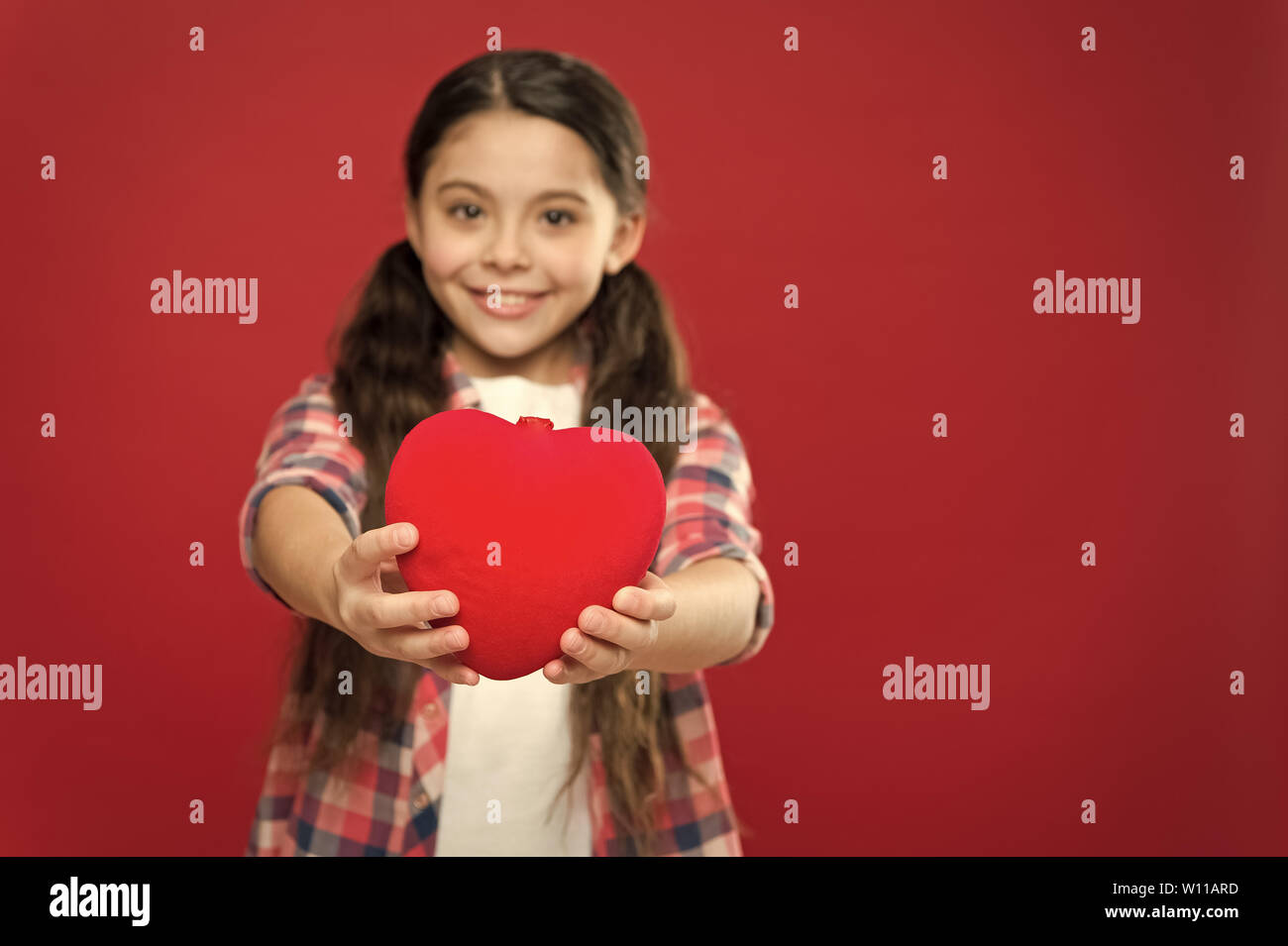 Giving you her heart. Cute girl in love. Little girl holding big red ...