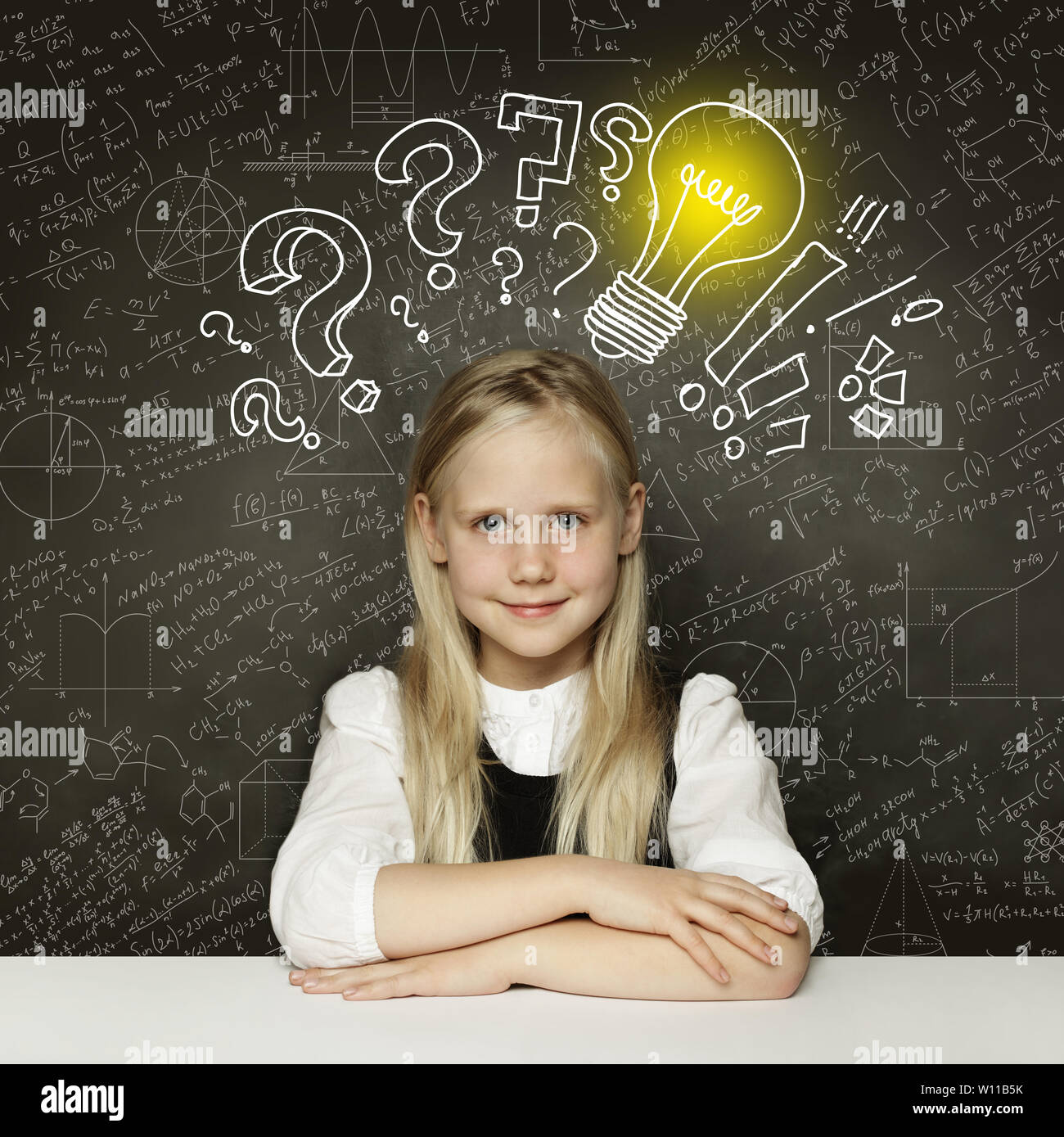 Idea! Smiling student girl with lightbulb on blackboard Stock Photo - Alamy