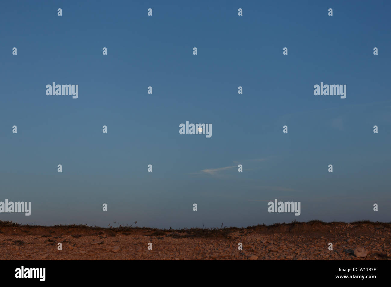 Full moon rise above desert Stock Photo - Alamy