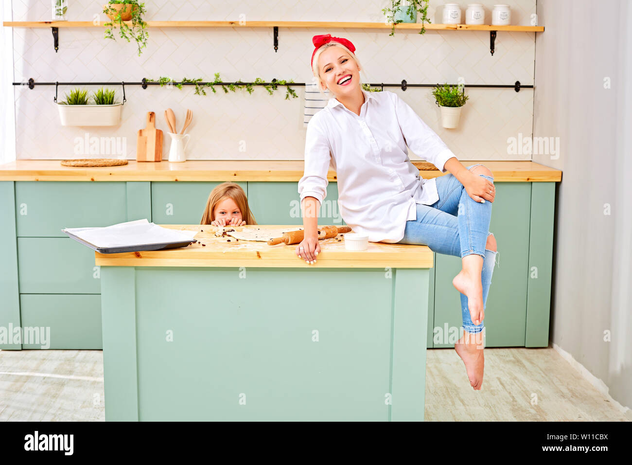 mom and daughter in the kitchen cook baked with Stock Photo - Alamy