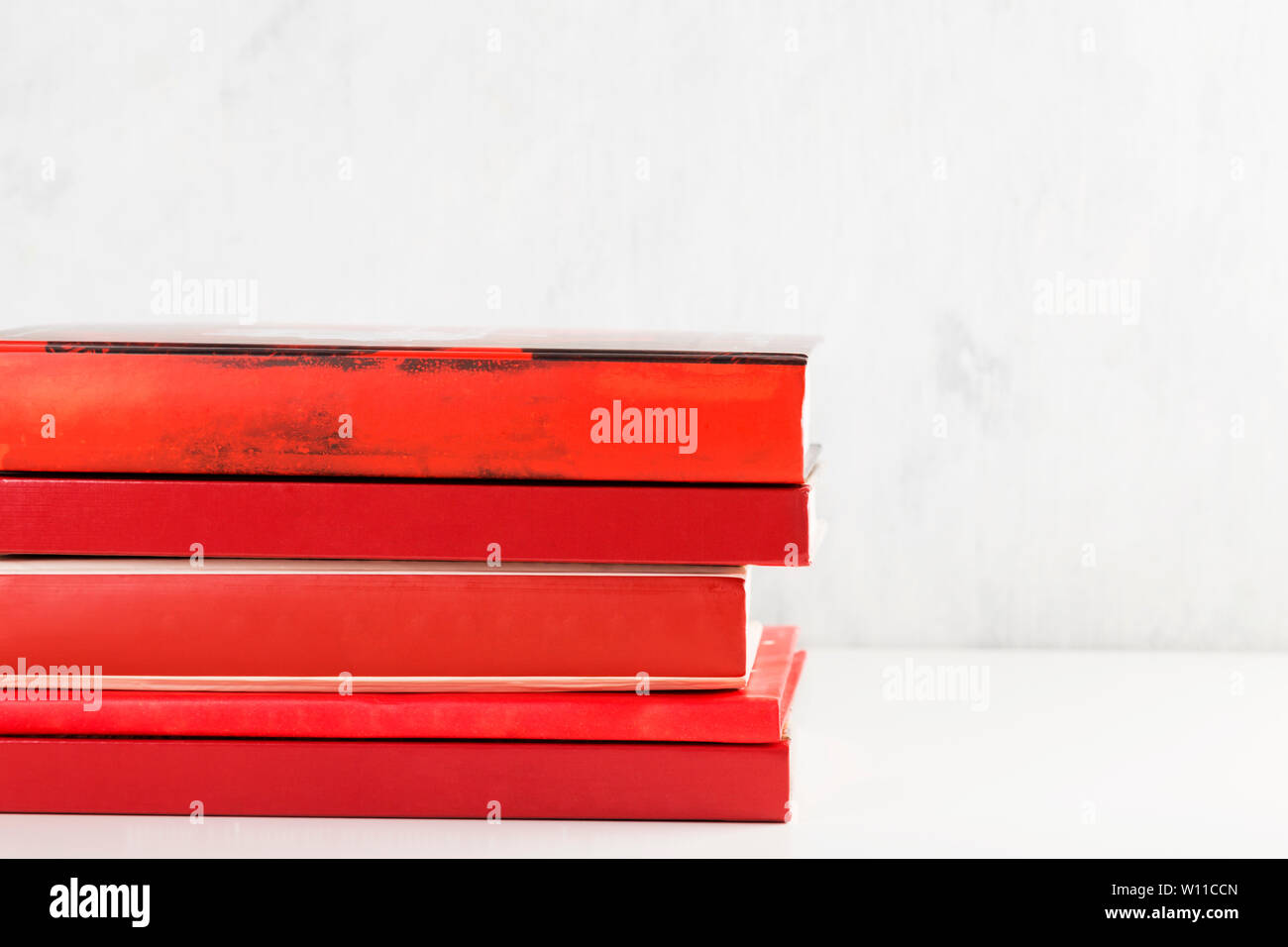 Stack red books on white background. Copy space Stock Photo - Alamy