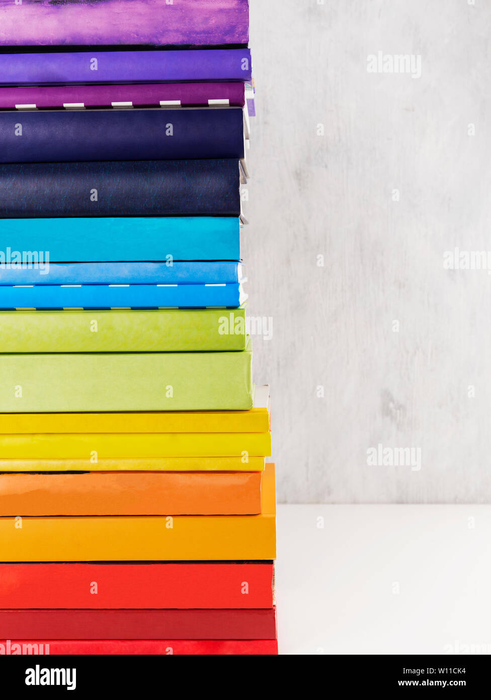 Stack of colorful rainbow books on white background. Copy space Stock ...