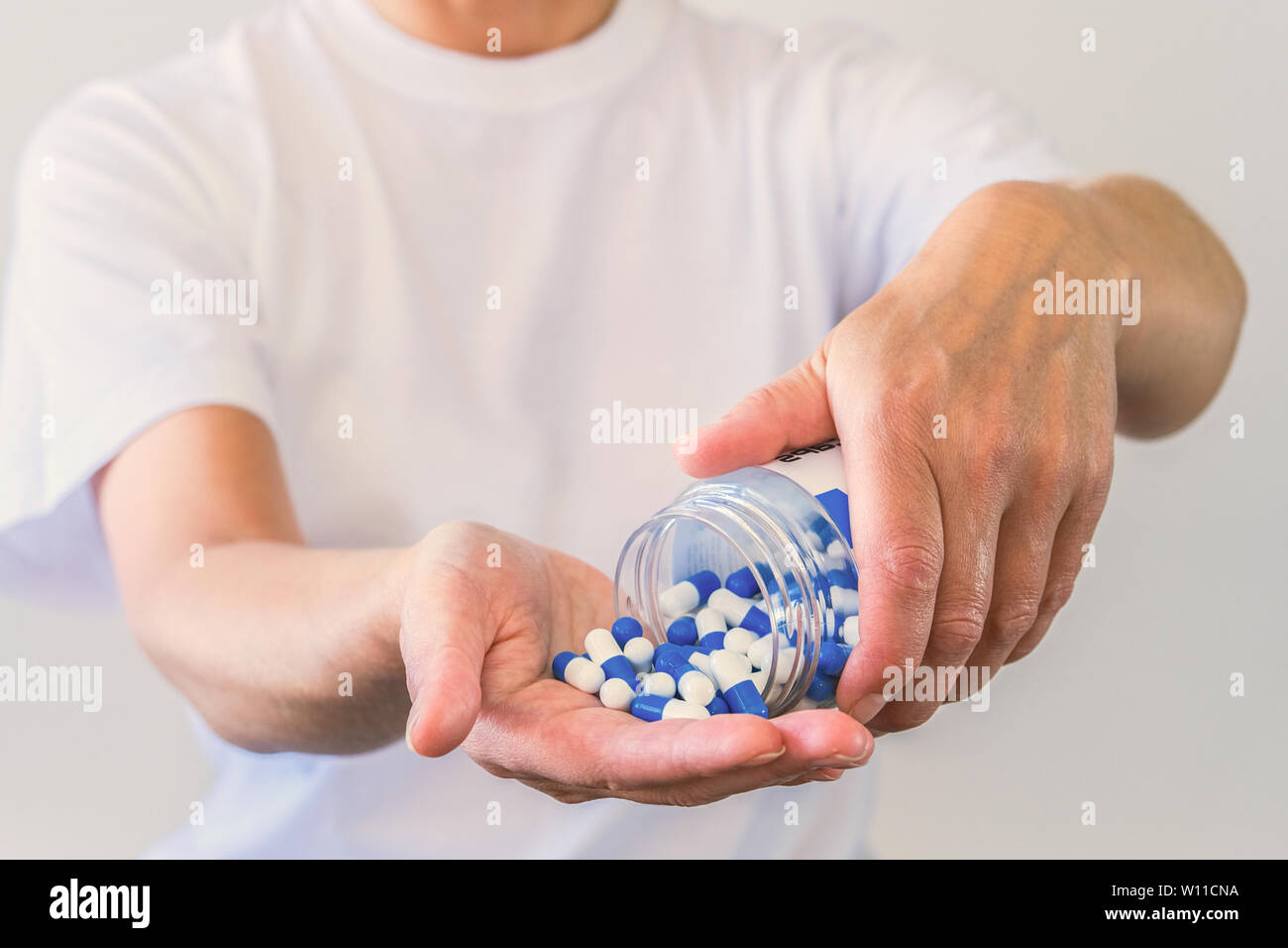 The woman poured a handful of sports capsules into the palm of her hand ...