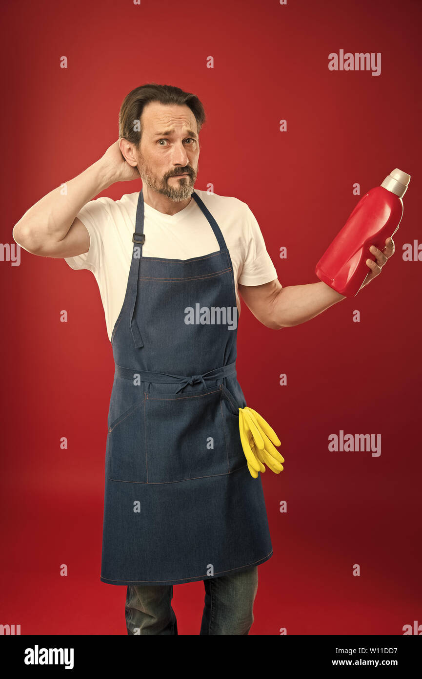 Man in apron with gloves hold plastic bottle liquid soap chemical ...
