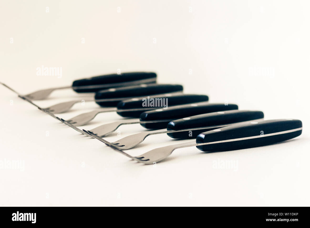 Close up six forks isolated on white background Stock Photo - Alamy