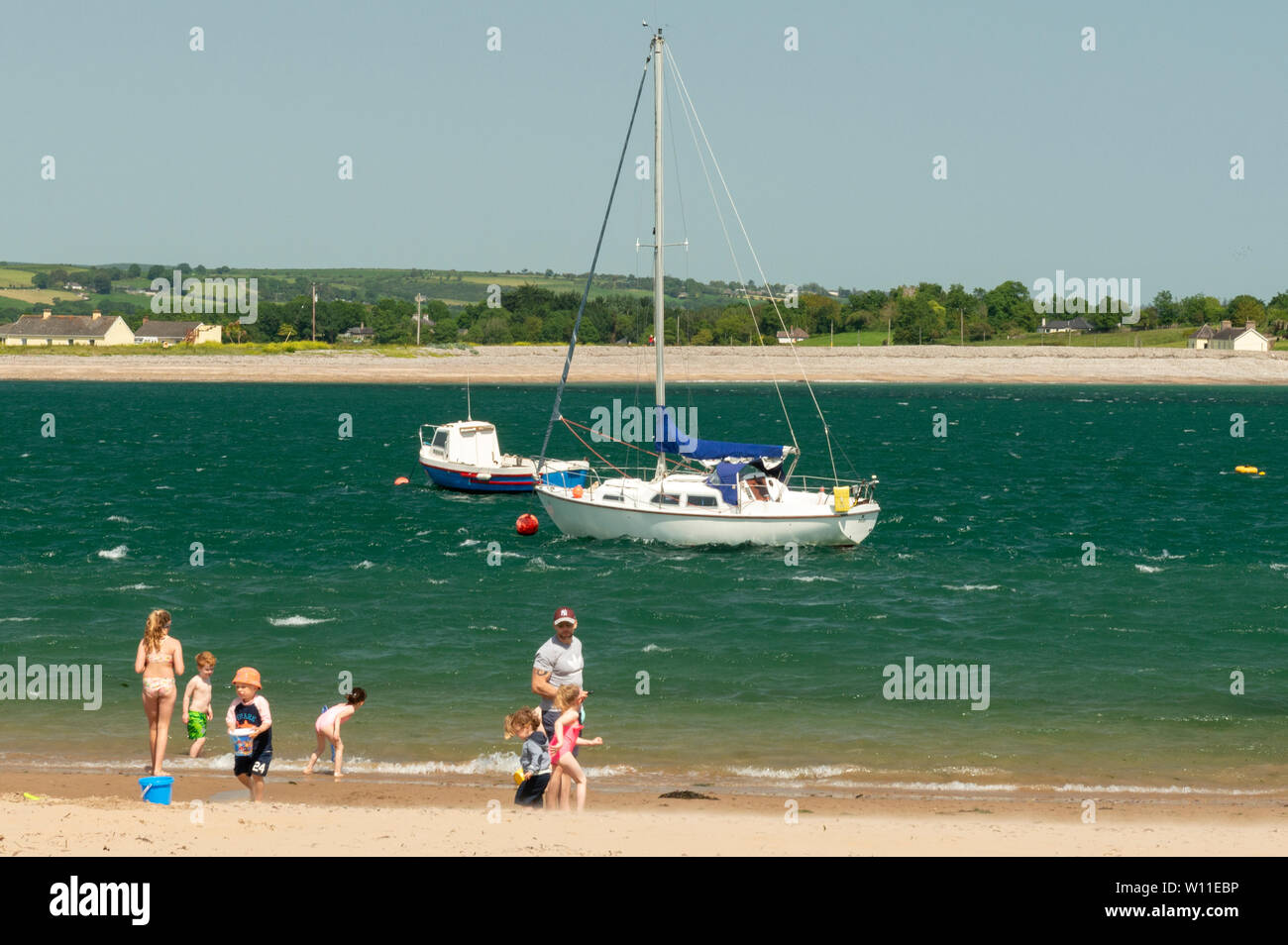 Sunny weather Ireland and Irish hot sunny summer. Beachgoers at the ...