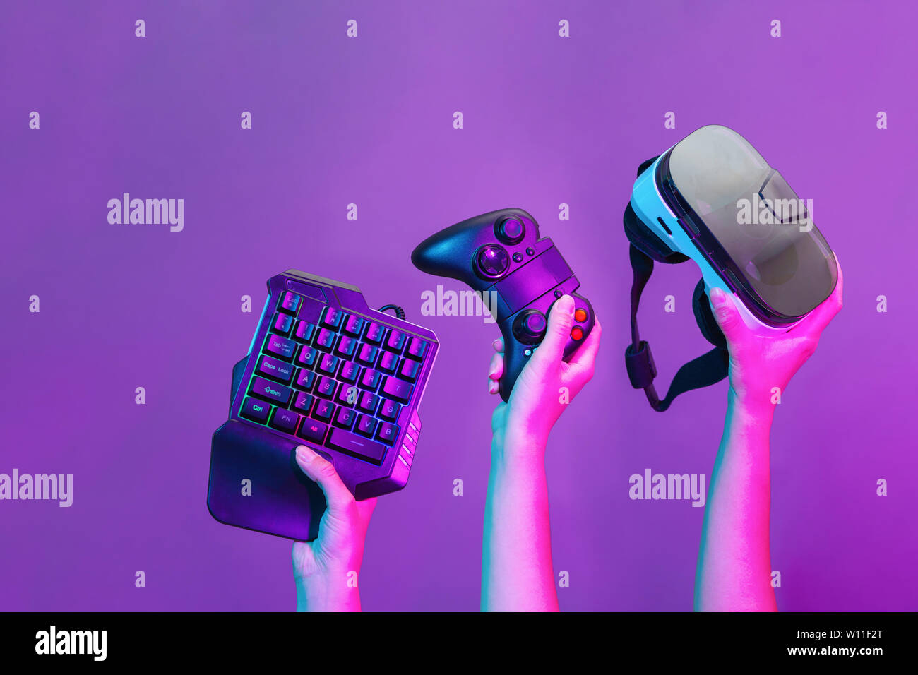 Set of hands with gamepad, keyboard, virtual reality headset and ...