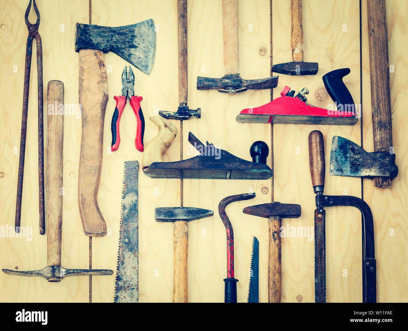 Set of vintage hand construction tools on a wooden background, retro ...