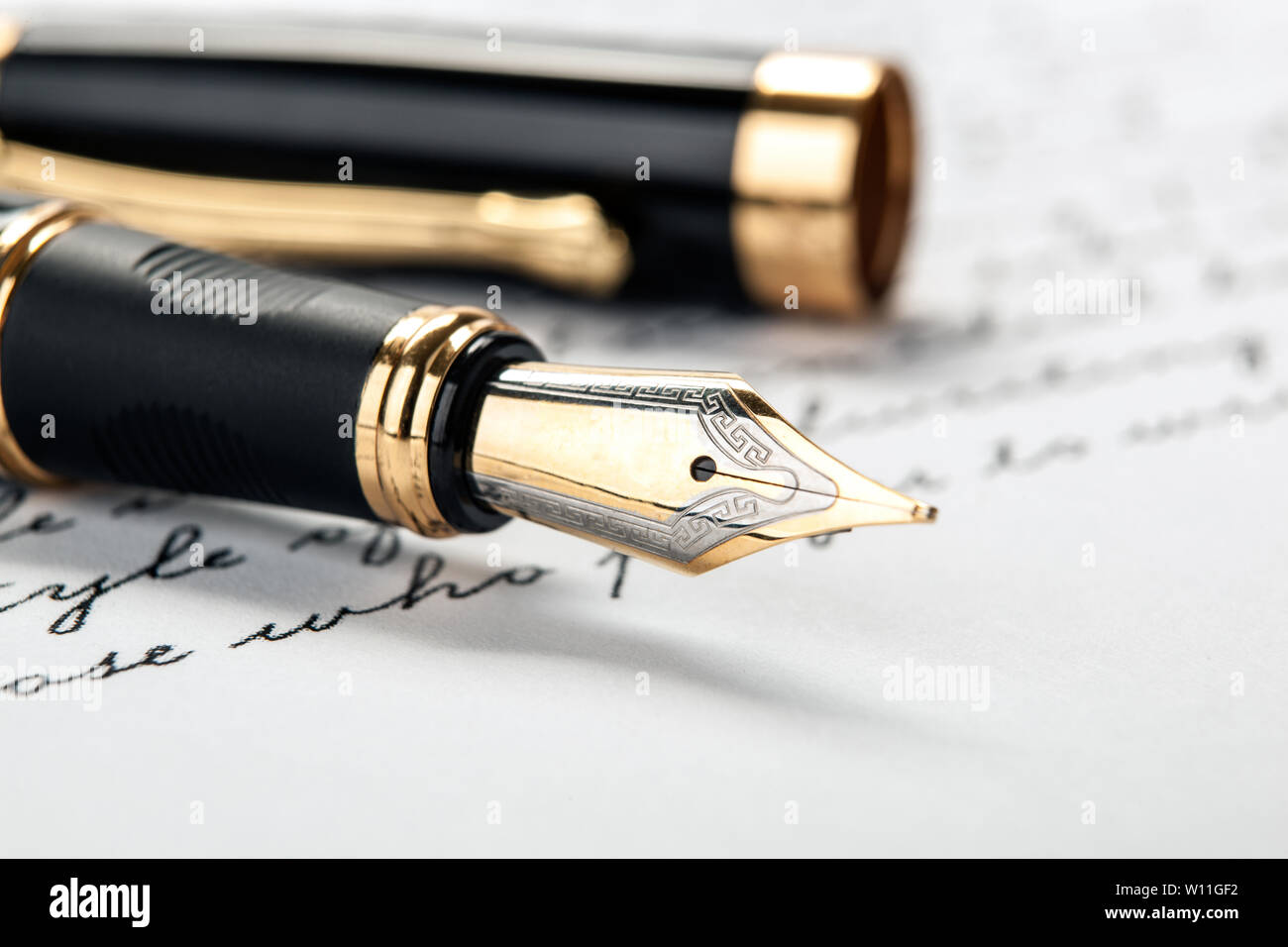 fountain pen on paper with ink text closeup Stock Photo - Alamy