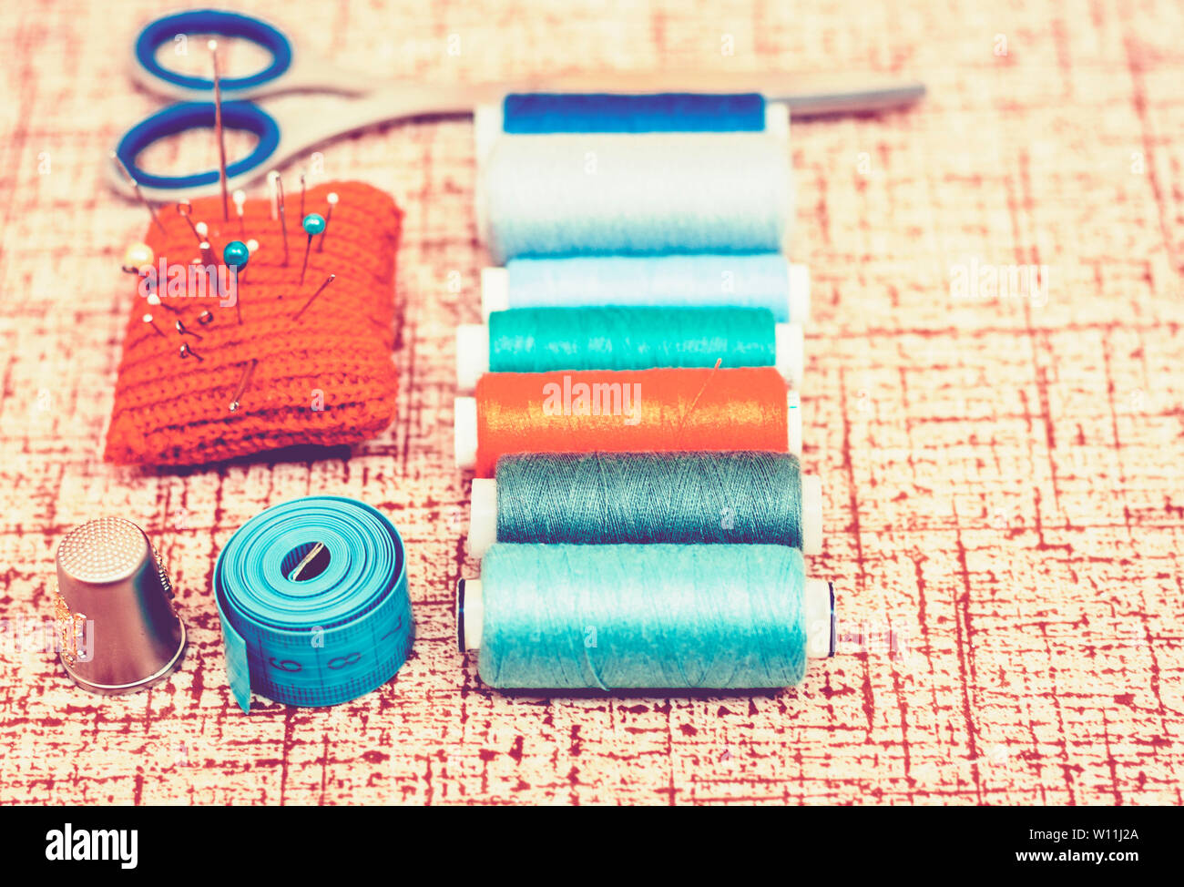 Tools for needlework, red knitted needle pad for sewing, scissors and ...