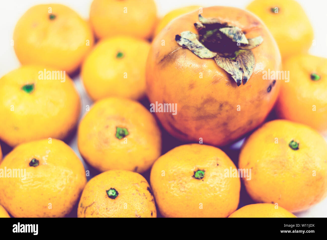 Fresh whole mandarin oranges background with Persimmon, top view Stock ...