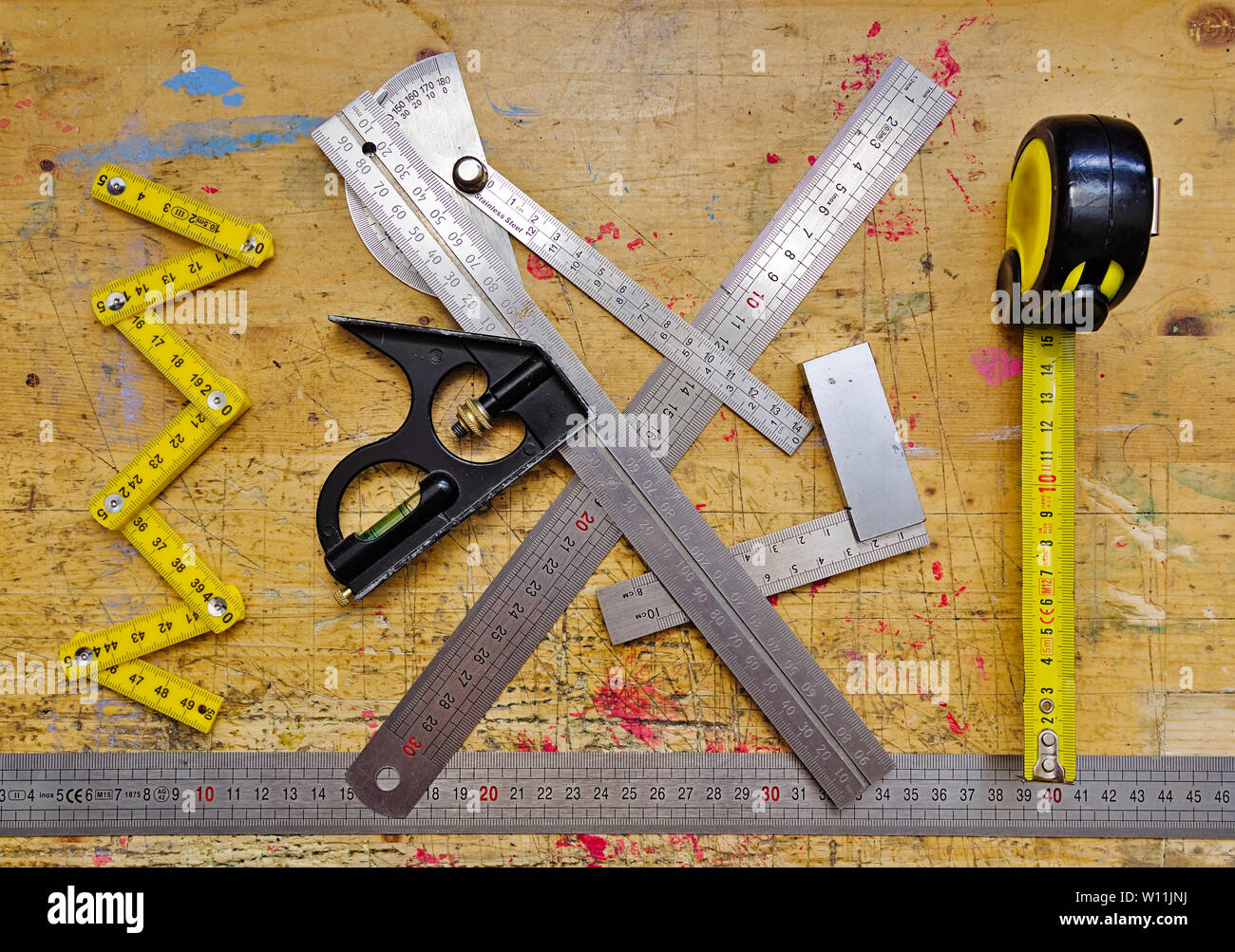 Various metering tools on wooden workbench grunge paint splashed ...