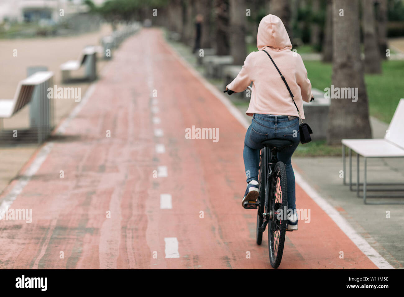 woman cyclist riding a bike on bike path on the embankment Stock Photo ...