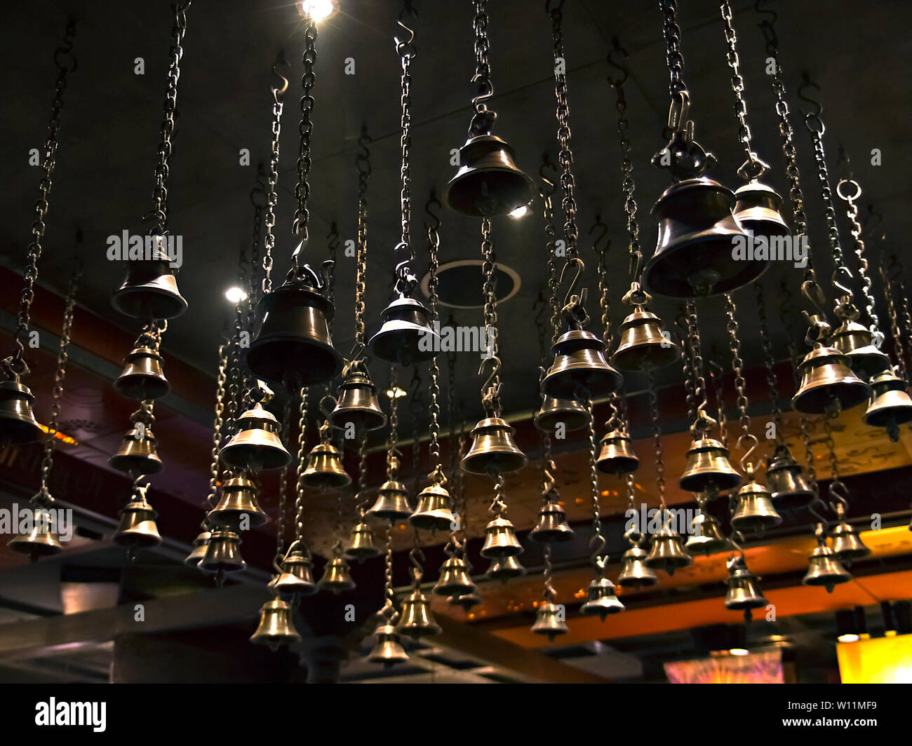 many ritual bells hanging on chains from the ceiling Stock Photo - Alamy