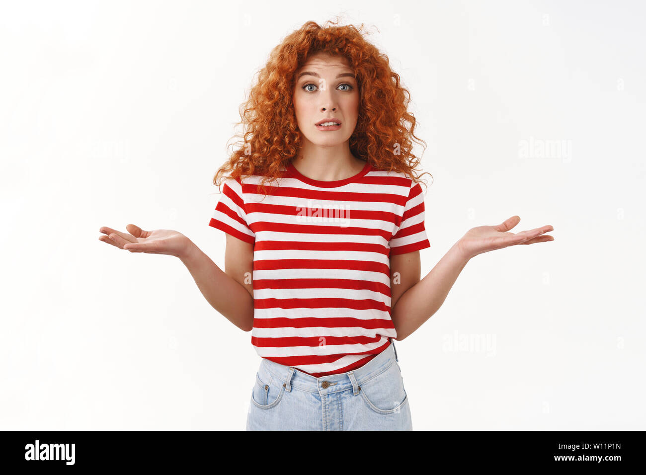 Confused redhead perplexed curly-haired girl cannot understand why boss ...