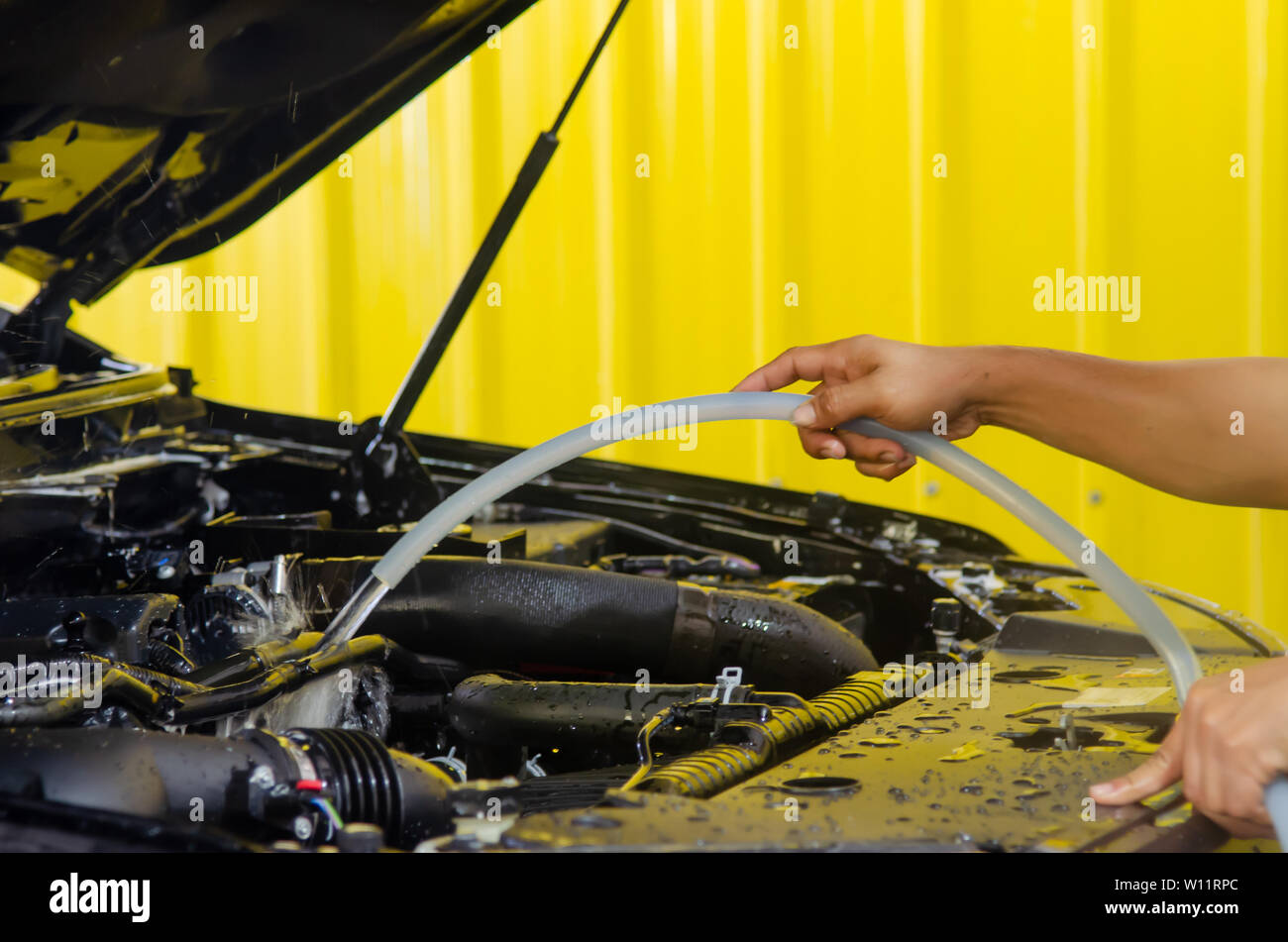 Cleaning engine with the foam Stock Photo - Alamy