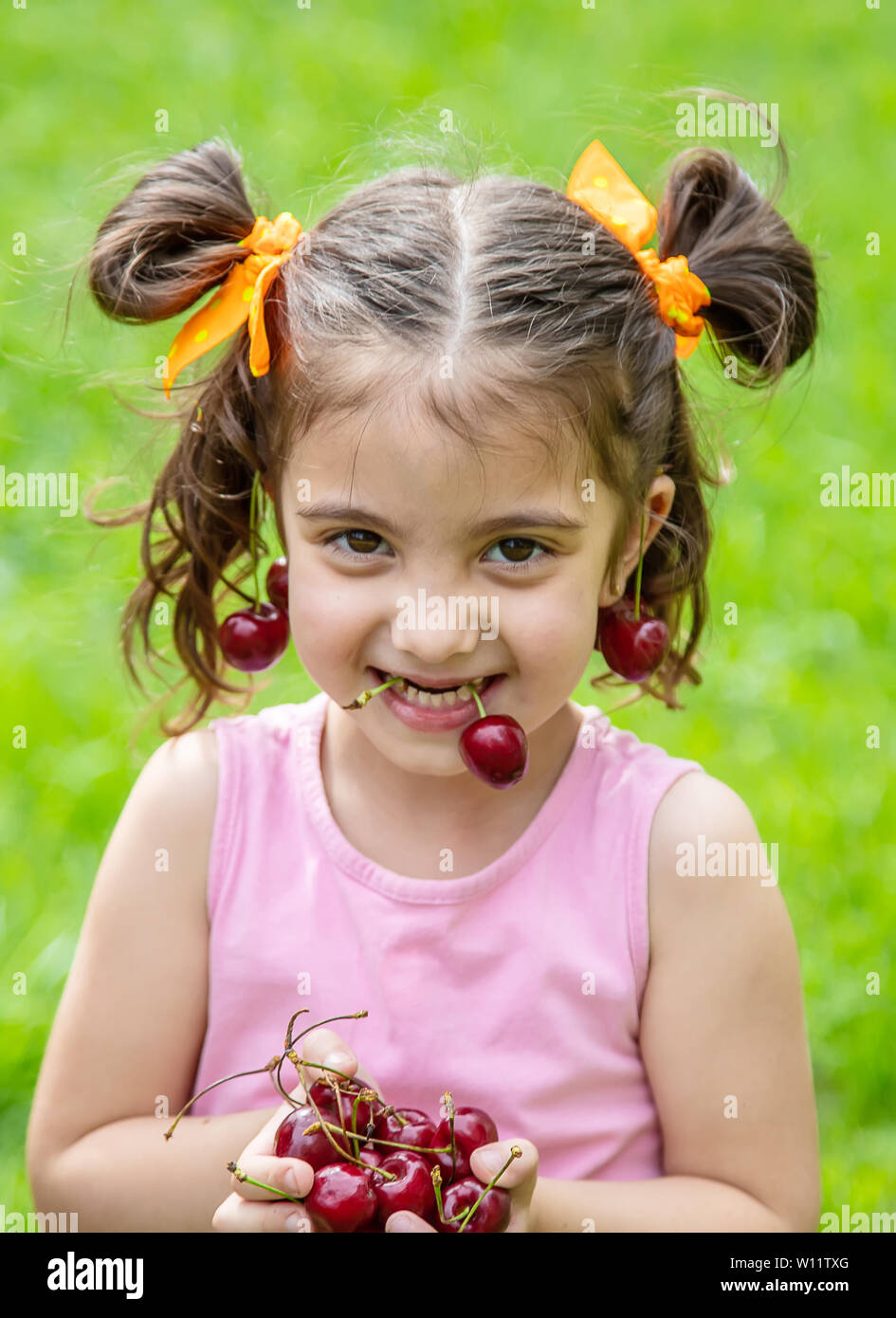Children eat cherries in the summer. Selective focus Stock Photo - Alamy