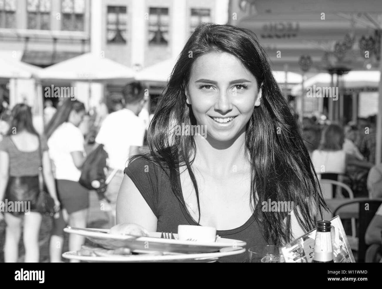 Poznan / Poland - beautiful girl, waitress carrying plates and smiling ...