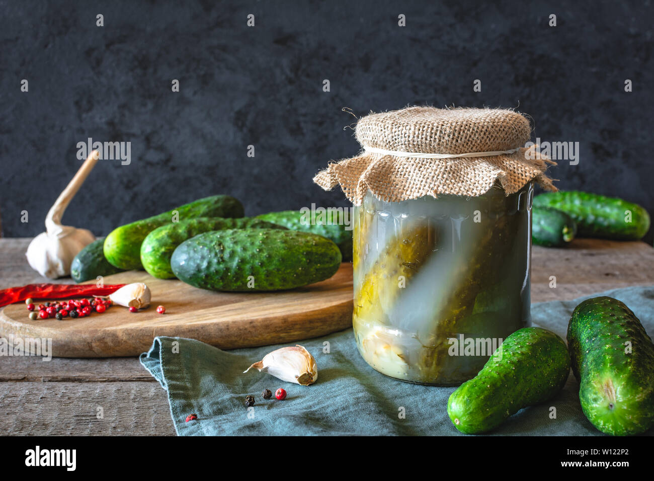 Pickled cucumbers with herbs and spices on dark background Stock Photo ...