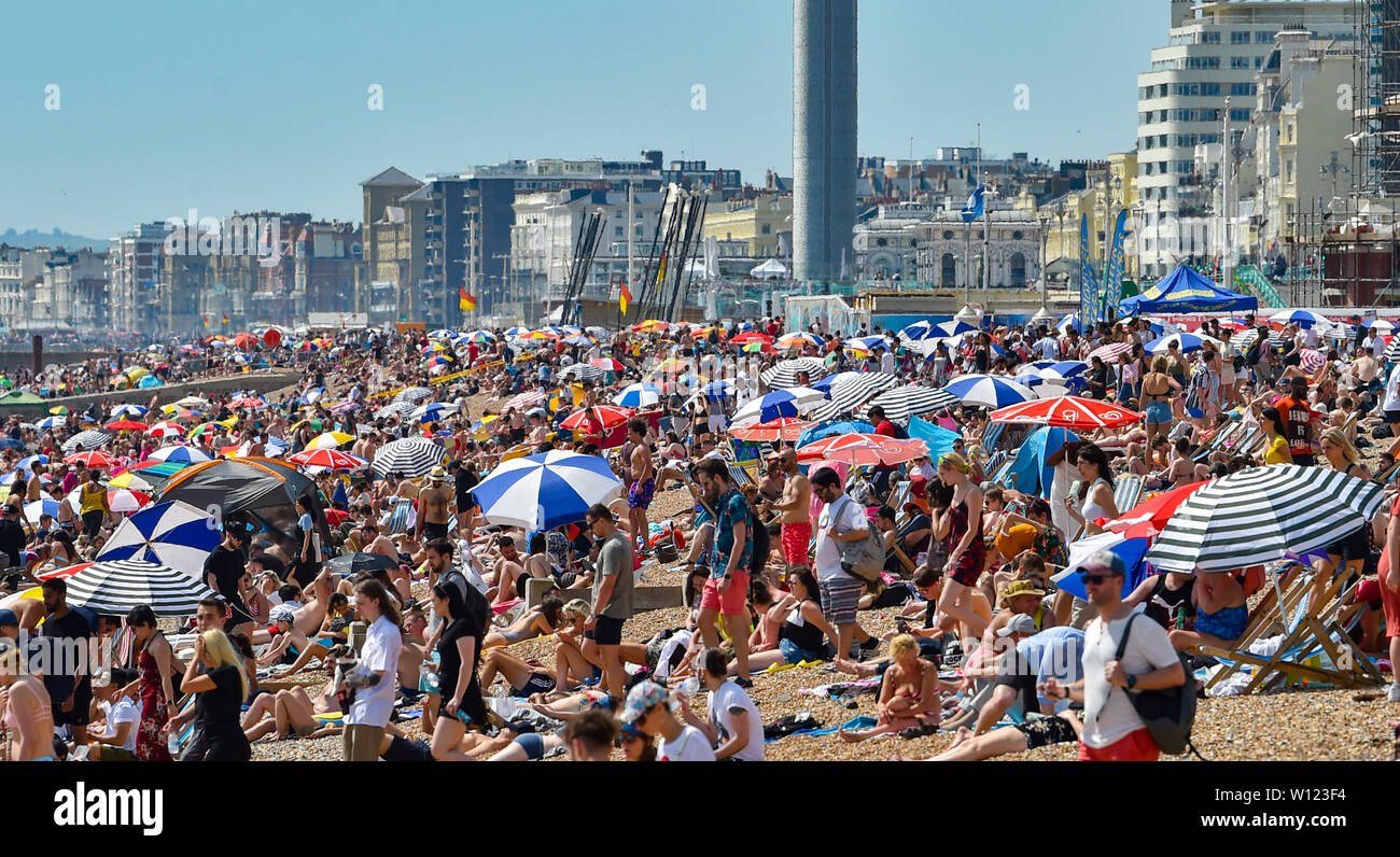Crowded beach in summer parasols umbrellas hi-res stock photography and ...